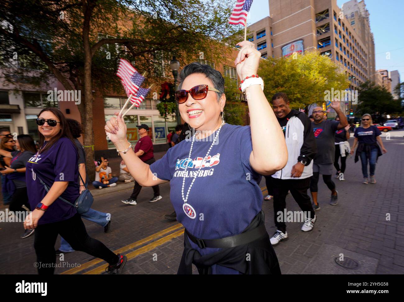 Jen Esquivel waves her flags while marching during Saturday's U.S ...