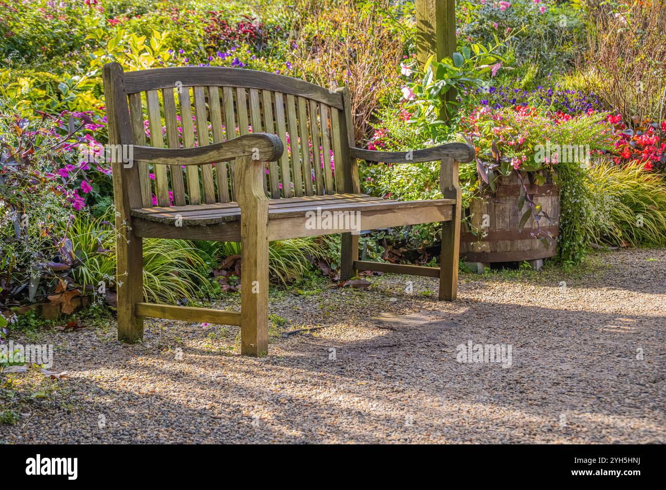 Wooden bench along a gravel path at Gibbs Gardens in Ball Ground ...