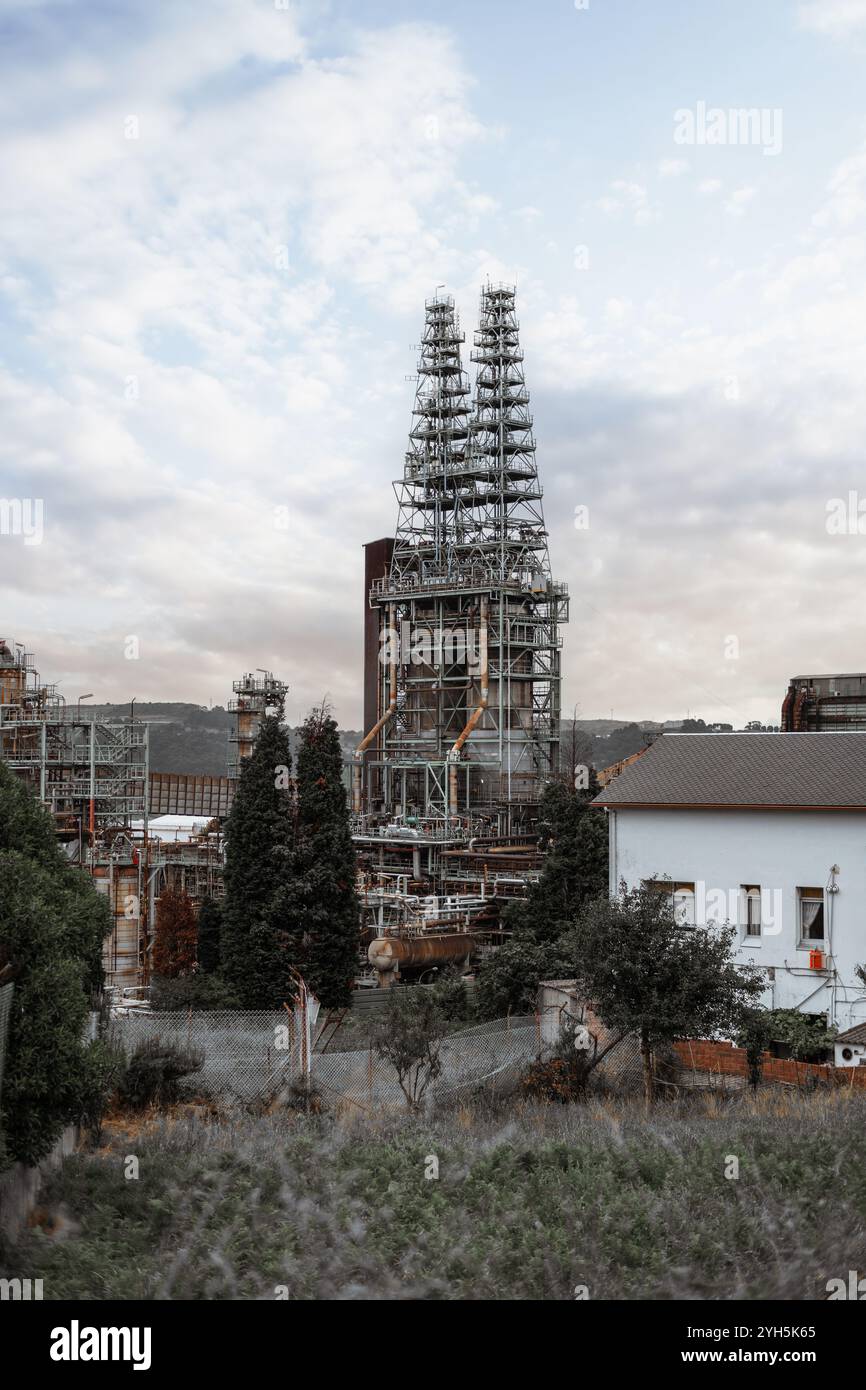 Industrial refinery plant with complex steel structures, pipes, and two ...