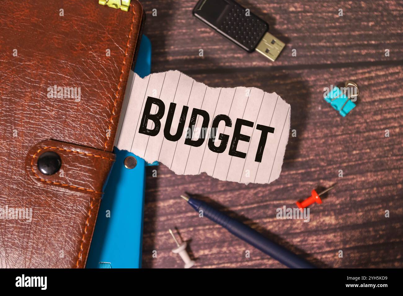 Budget wording or text on ripped paper edge cardboard with grey ...