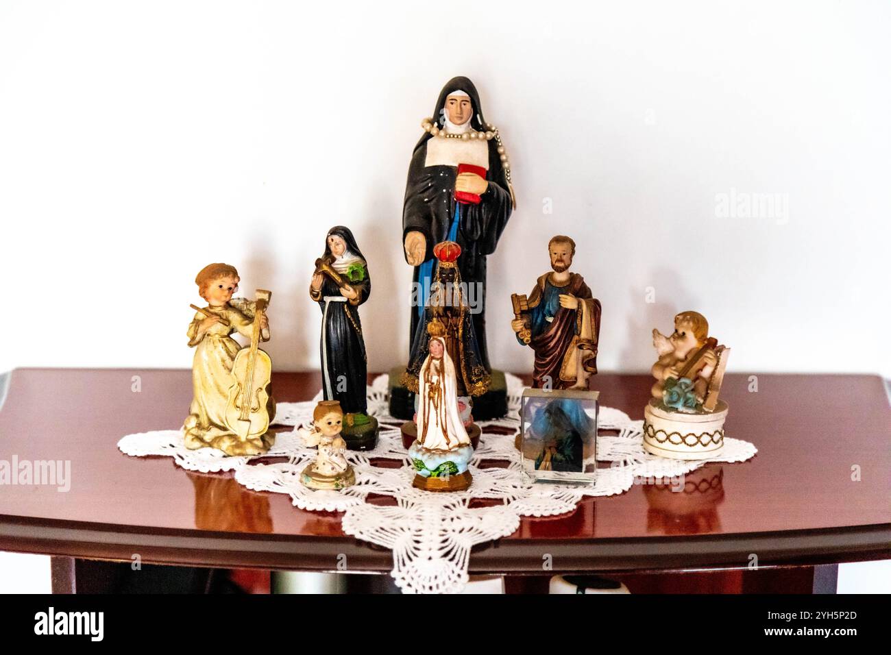 Group of various religious images on a rustic table Stock Photo - Alamy
