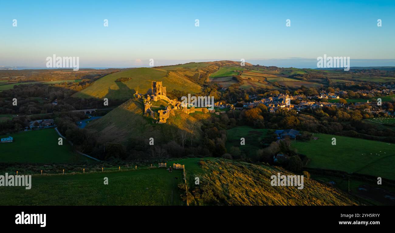 Aerial sunset view of Corfe Castle, a village and civil parish in the ...