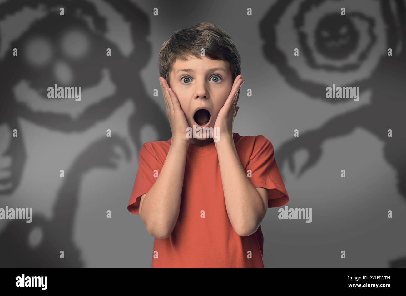 Boy scared of monsters, teraphobia. Creepy shadows behind him Stock ...