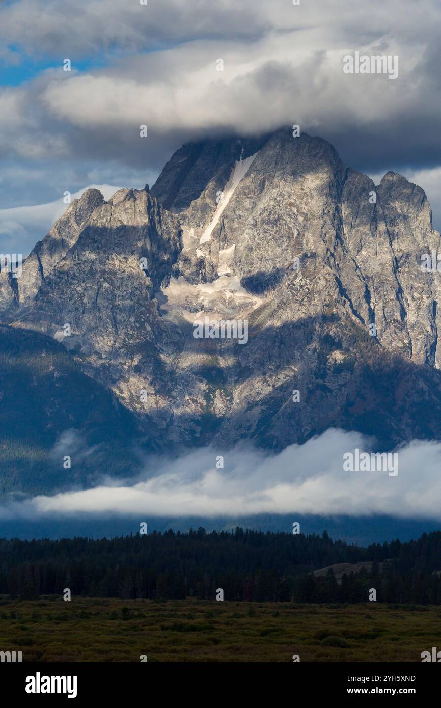 Willow Flats lying below Mount Moran as it emerges from a clearing fog ...