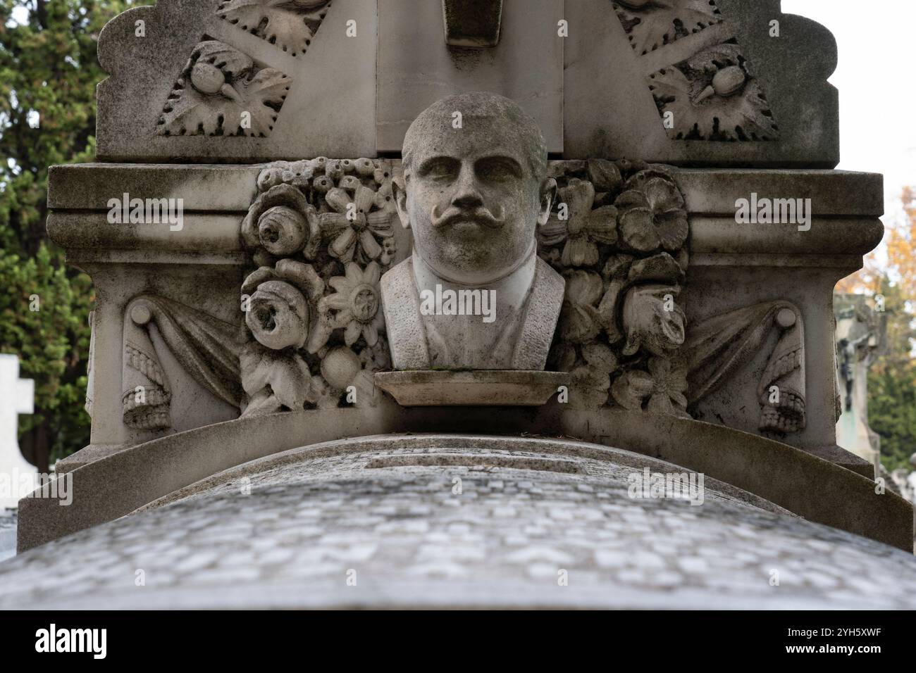 An ornate gravestone adorned with the bust of a man buried at Our Lady ...