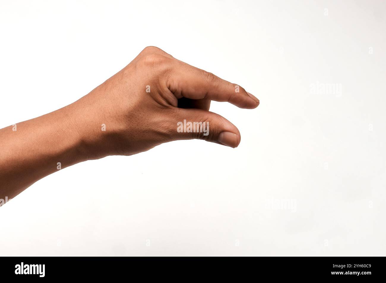 Hand of a Latino man holding something small, isolated on white ...