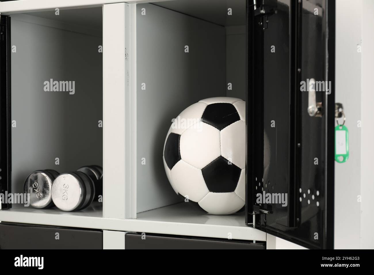 Open lockers with dumbbells and soccer ball, closeup Stock Photo - Alamy