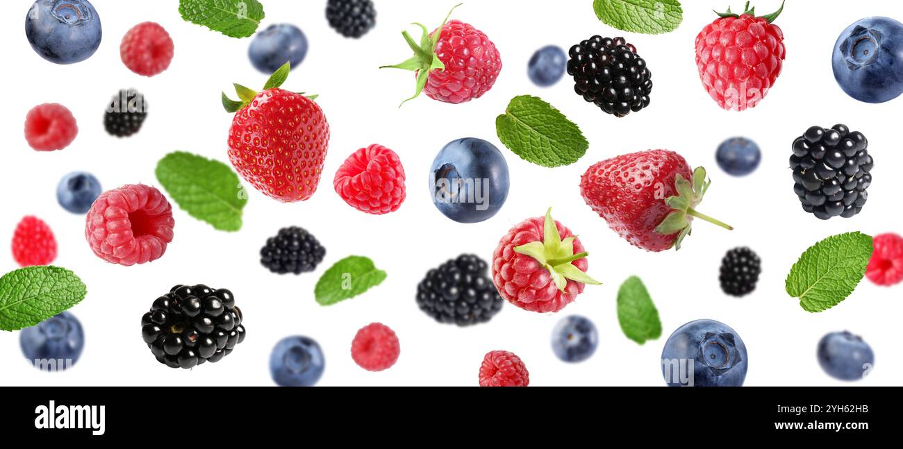 Mix of fresh berries in air on white background Stock Photo - Alamy