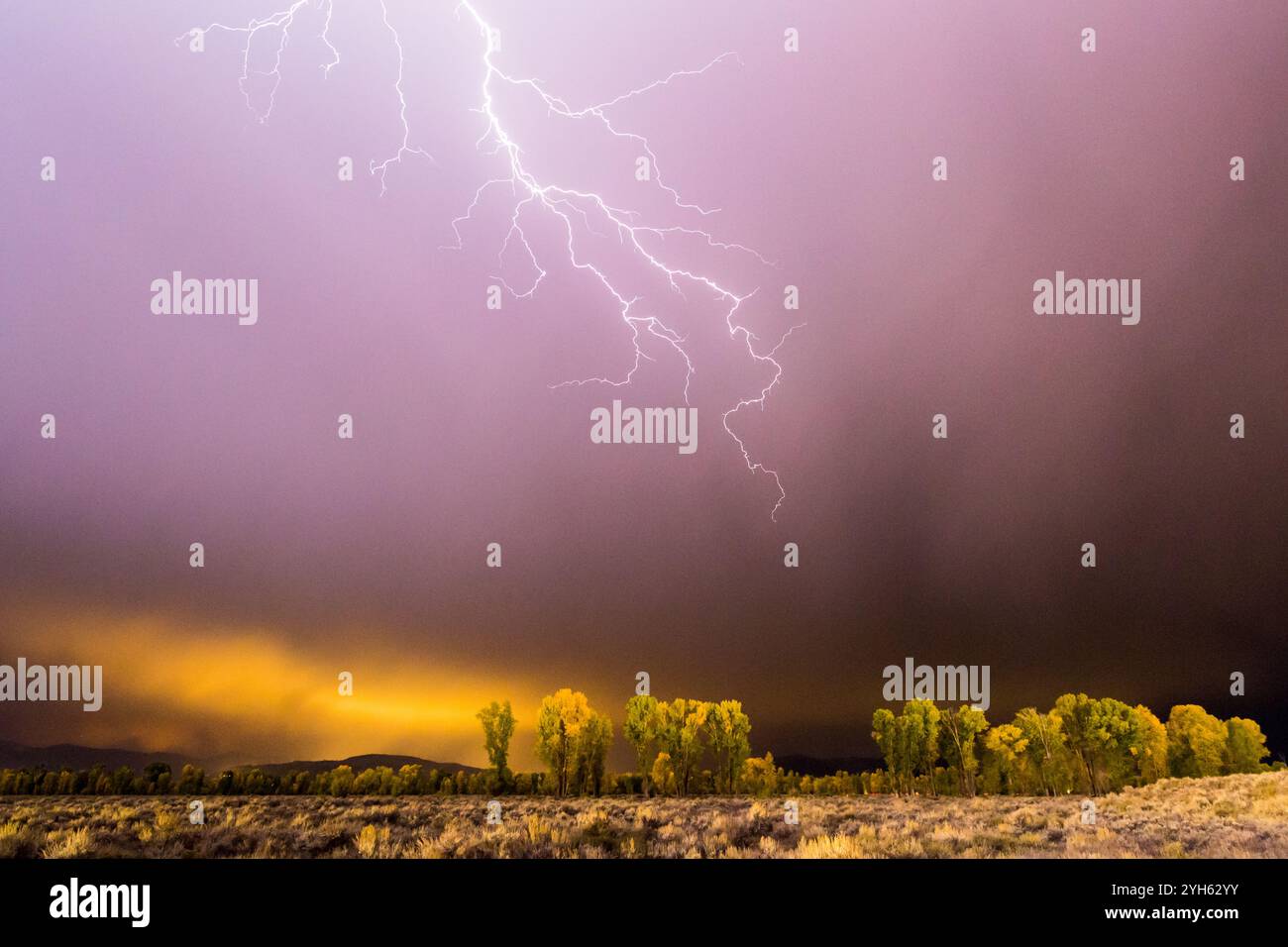 A lightning bolt strikes toward Jackson Hole, Wyoming during a storm ...