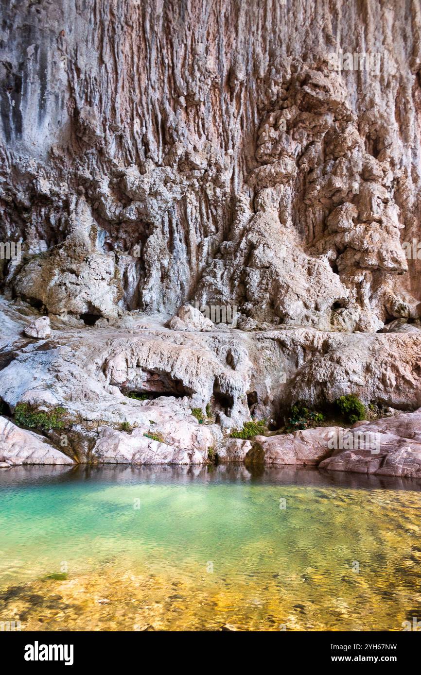 A colorful pool resting below the walls of Tonto Natural Bridge. Tonto ...