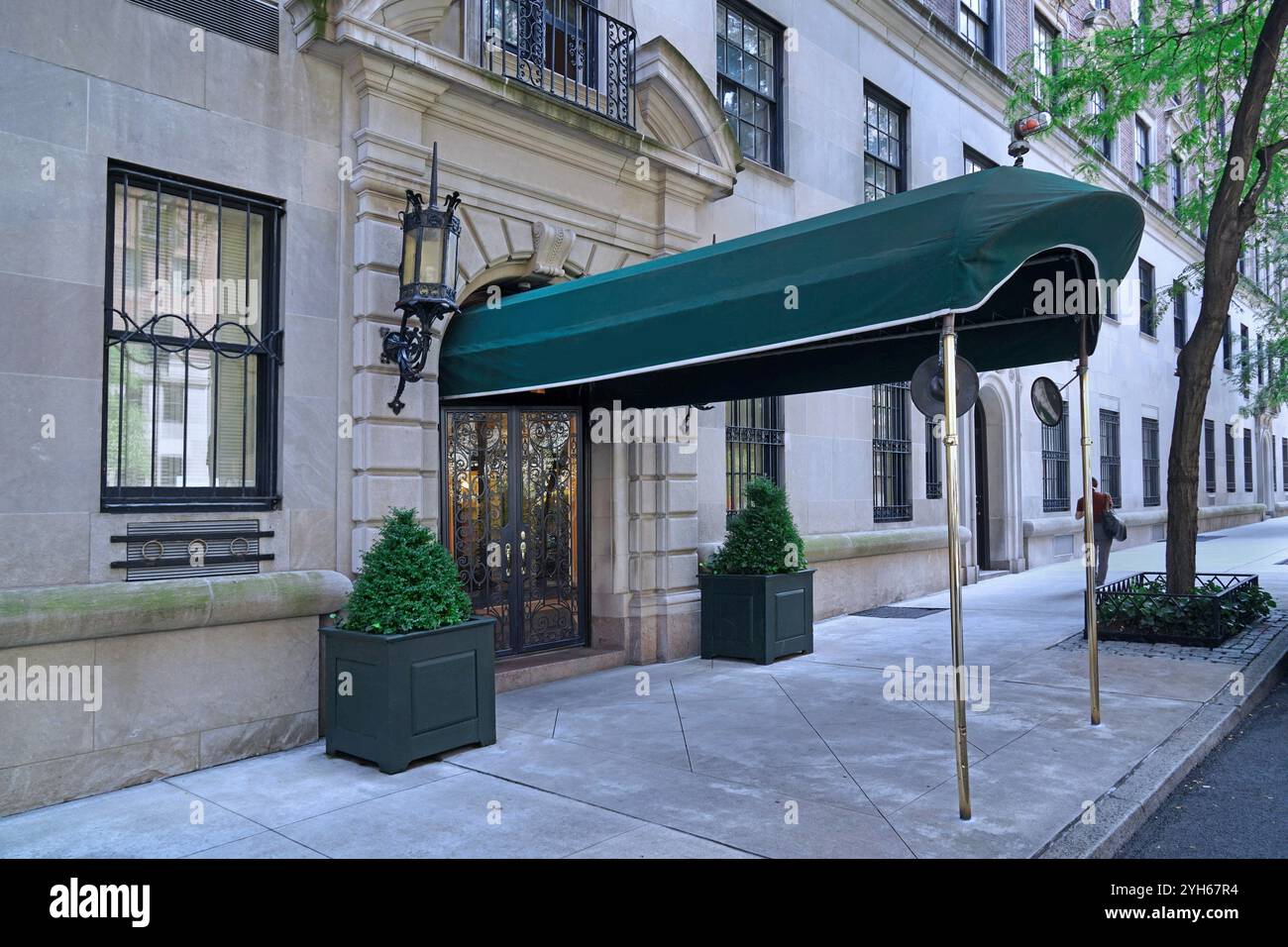 Manhattan sidewalk with awning above entrance to apartment building ...