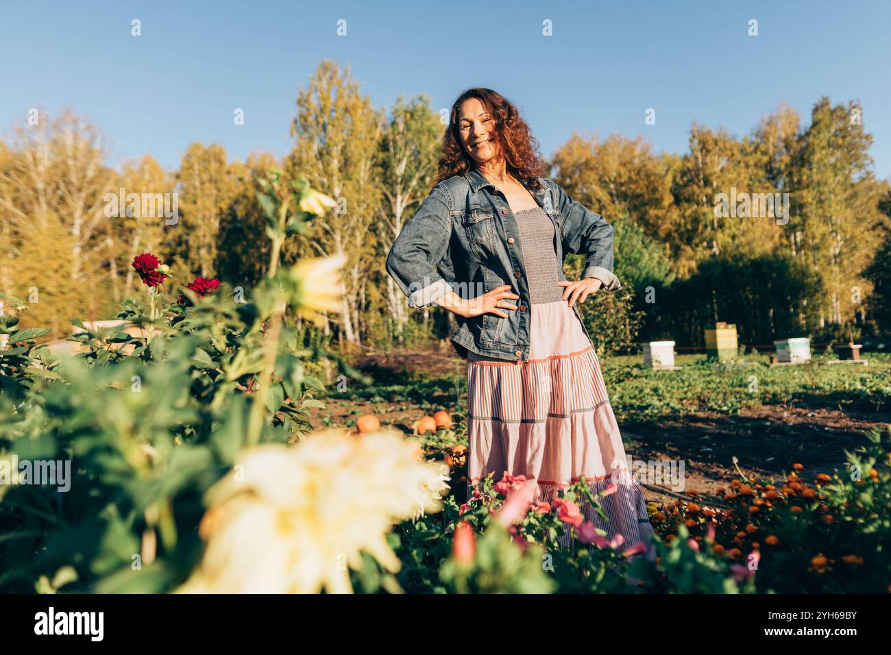 Woman celebrating the simple joys of rural life with open arms in her ...