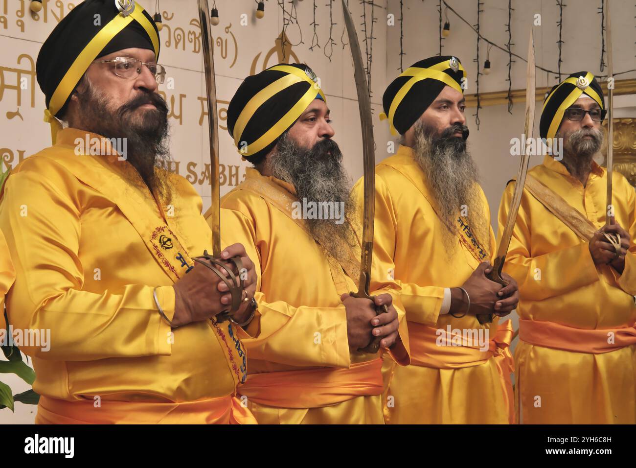 Sikh men in festive attire and with ceremonial swords at Siri Guru ...