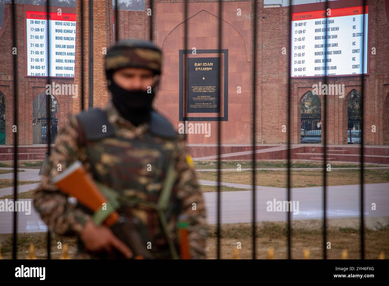 Indian paramilitary soldier stands on guard past electronic signage ...