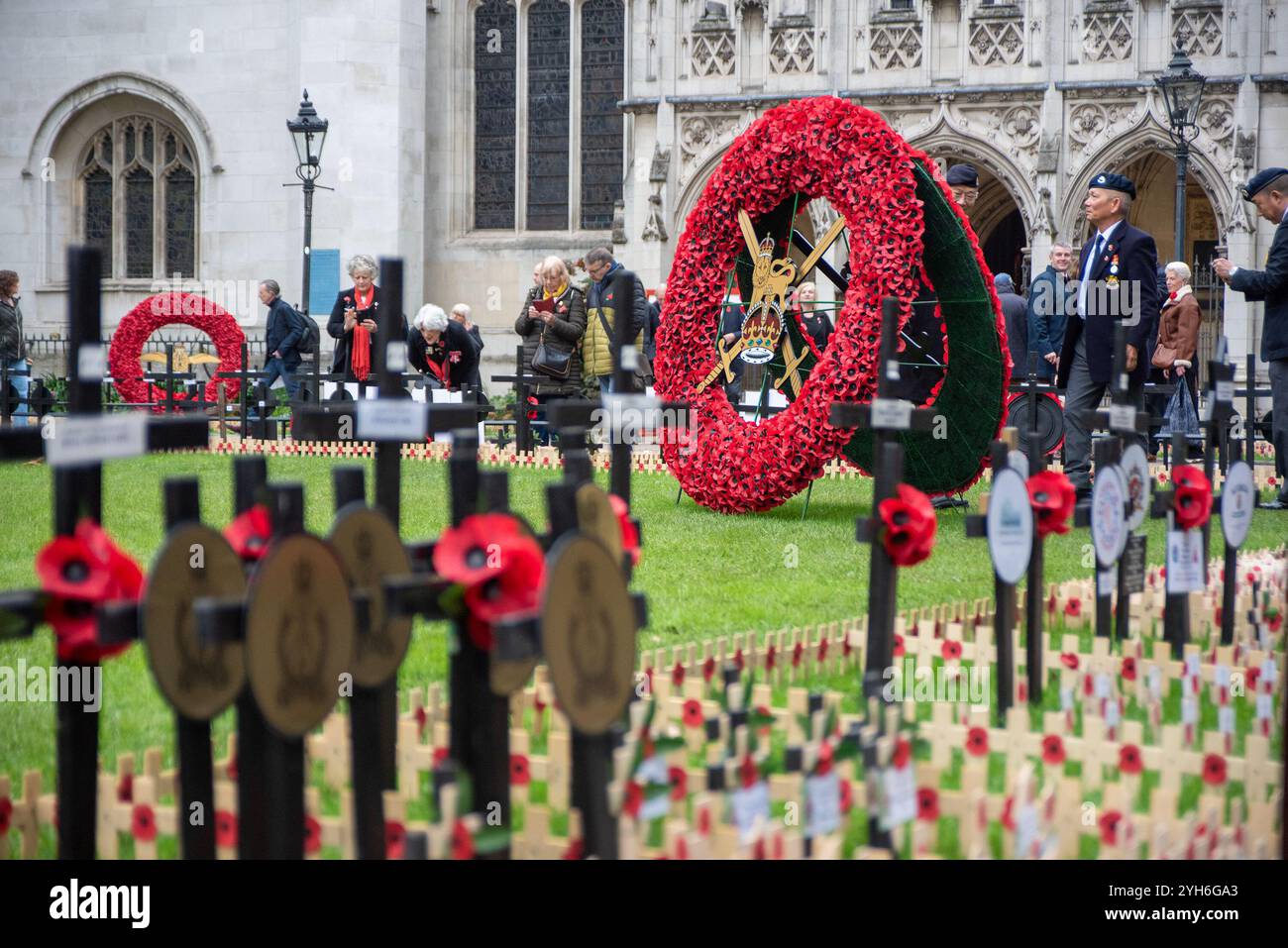 People walk by the crosses and wreaths on the Field of Remembrance at ...