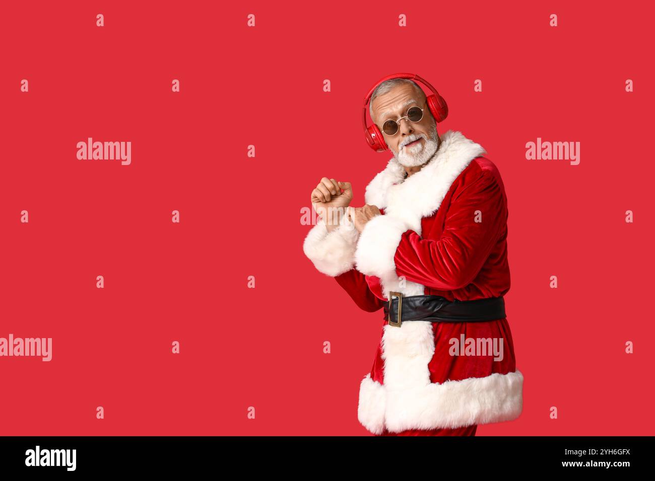 Santa Claus in headphones listening music on red background Stock Photo ...