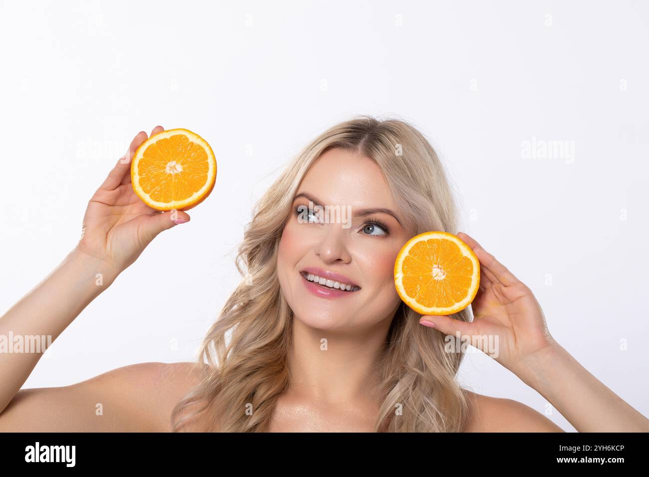 A Fresh and Vibrant Woman Holding a Bountiful Display of Juicy Oranges ...