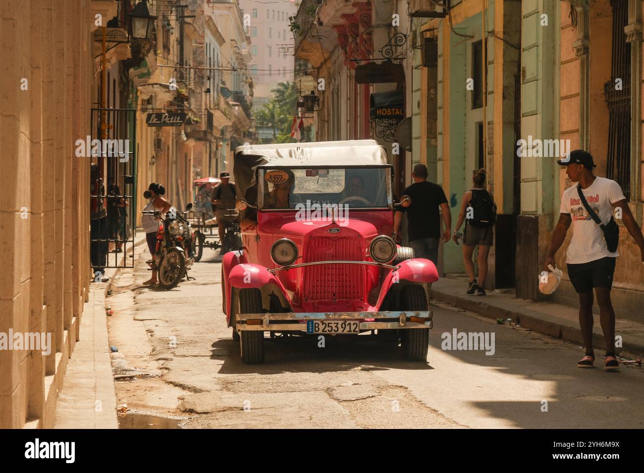 Havana, Cuba 2024 Apr17. Old Ford model vintage car taxi with passenger driving through streets ...