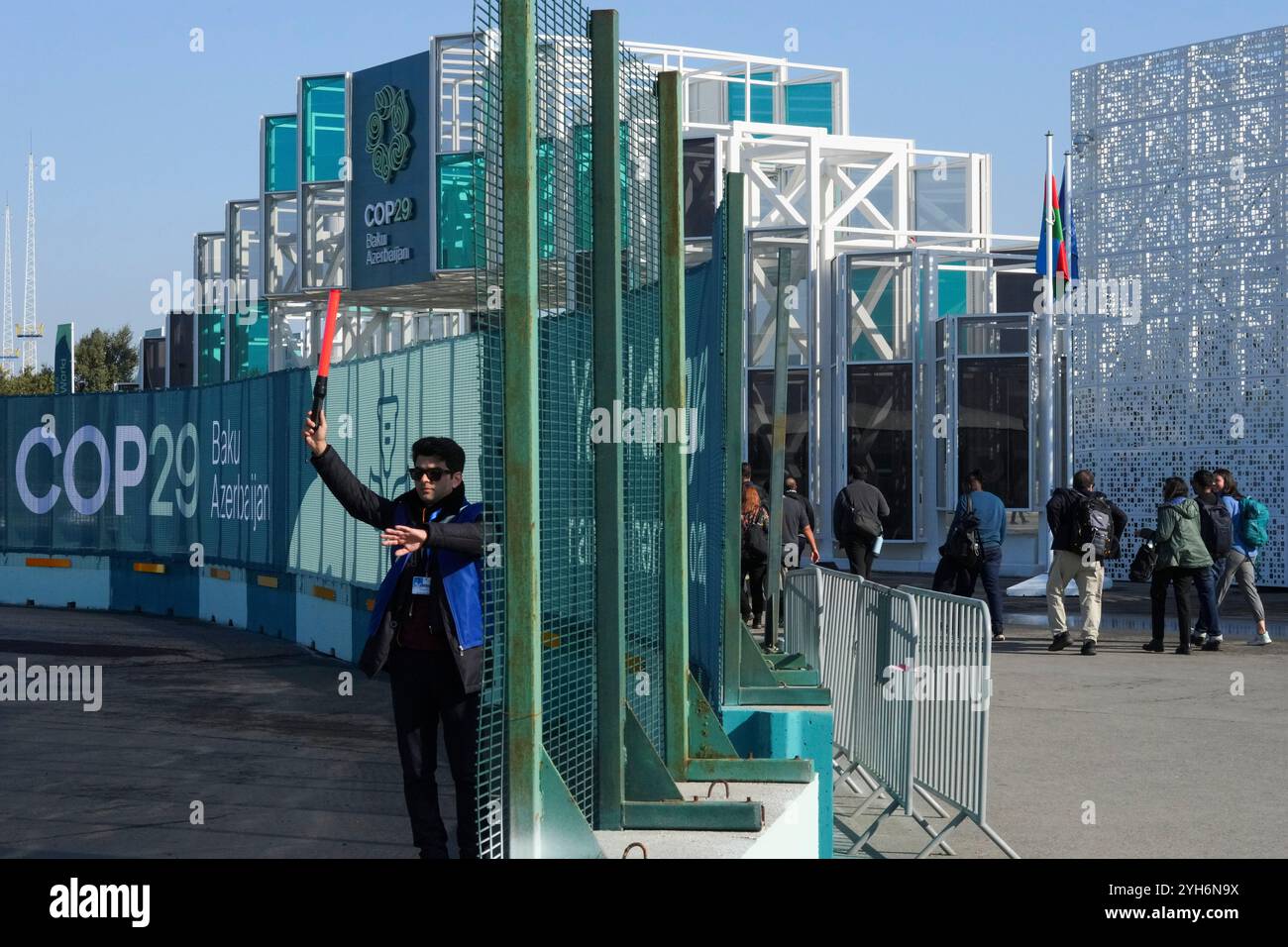 A person directs traffic outside of the venue for the COP29 U.N ...