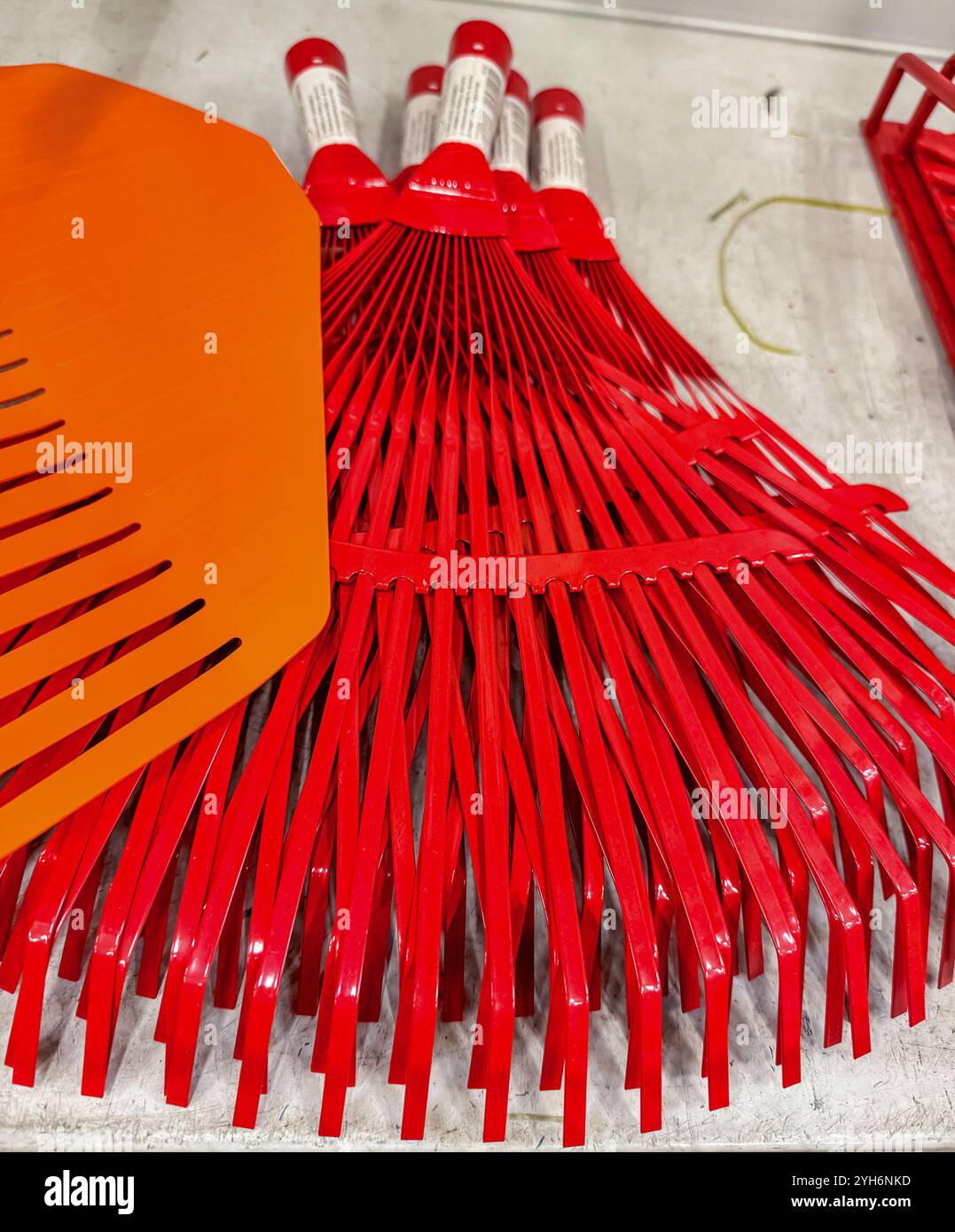 new red rakes for leaves in warehouse . High quality photo Stock Photo ...