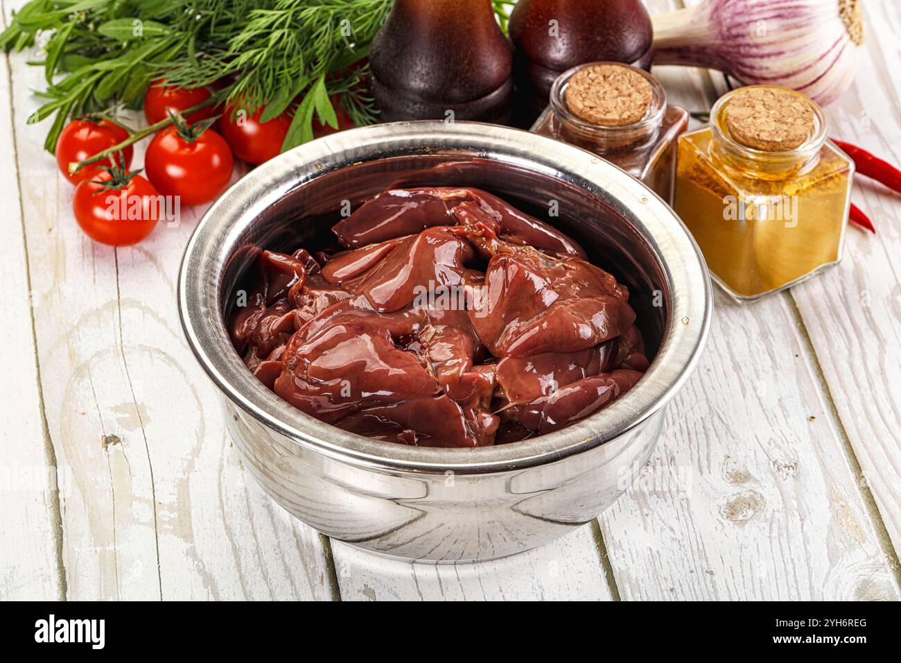 Raw chicken liver uncooked in the bowl with spices Stock Photo - Alamy