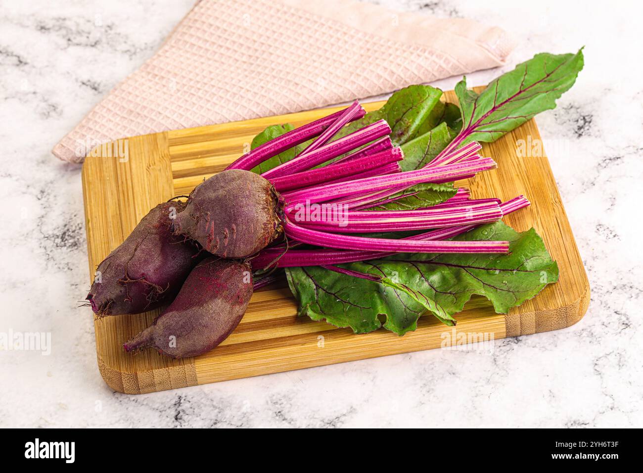 Young red fresh beetroot with leaves over board Stock Photo - Alamy