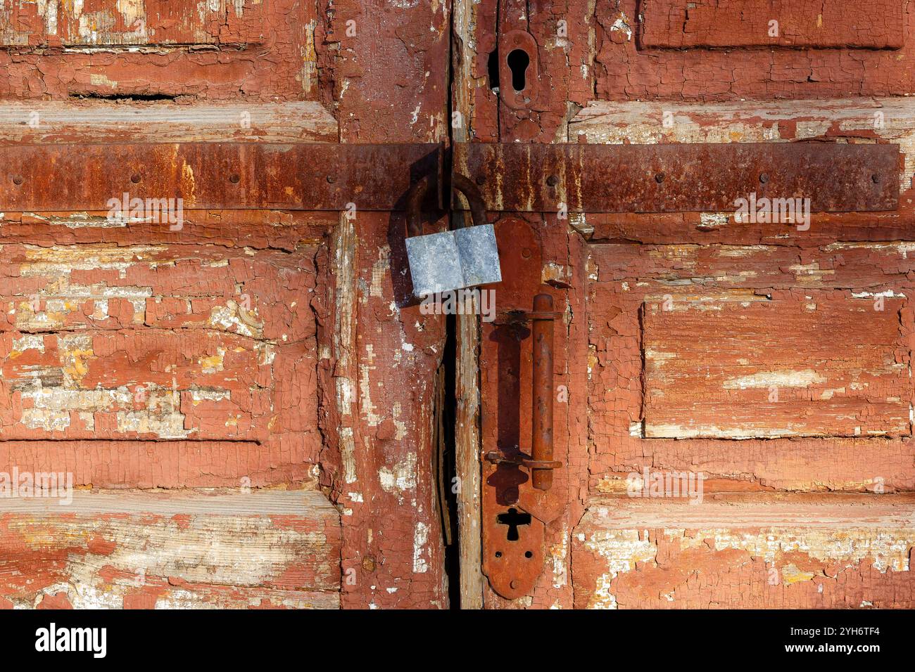 Old traditional wooden door with metal lock close-up. Metal lock for ...