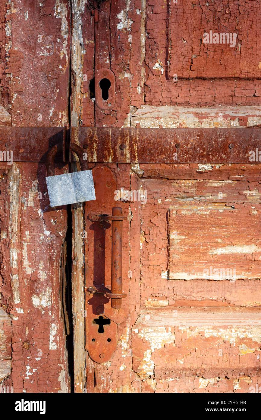 Old traditional wooden door with metal lock close-up. Metal lock for ...