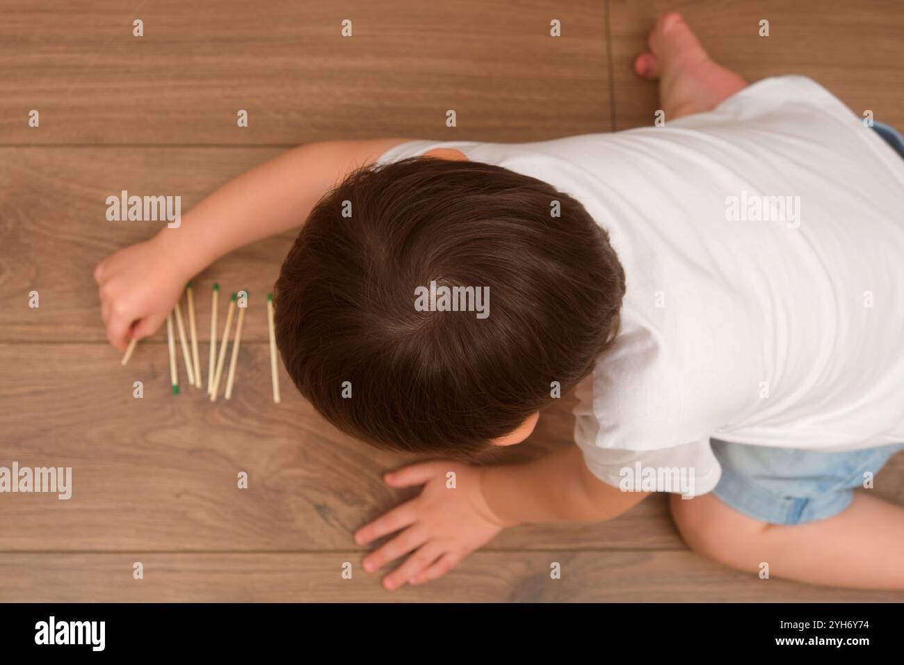 A matchstick in the child's hand can quickly lead to a fire hazard. The ...