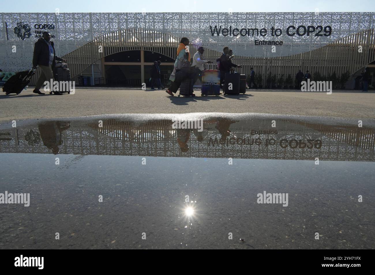 People walk outside the entrance for the COP29 U.N. Climate Summit ...