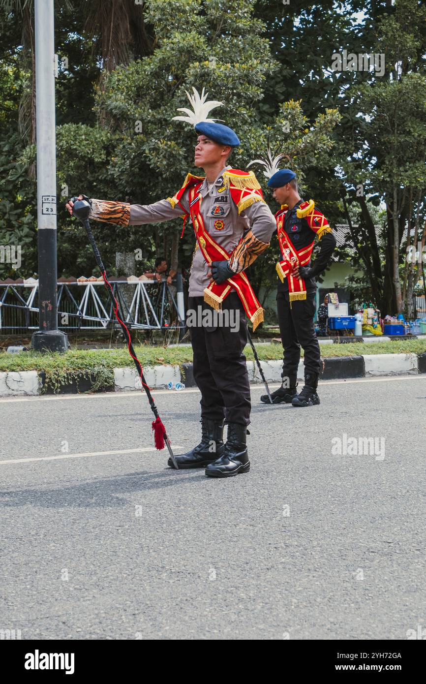 A police officer prepares his concentration during a marching band ...