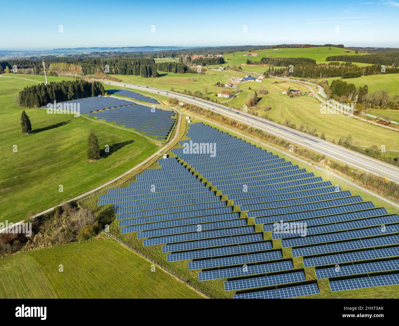 aerial view of a huge photovoltaik power plant next to a highway in ...