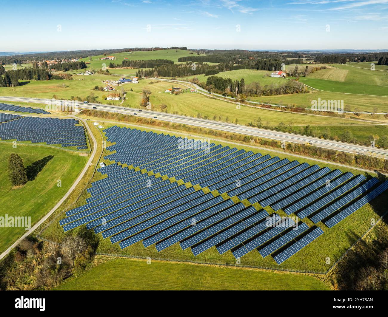 aerial view of a huge photovoltaik power plant next to a highway in ...