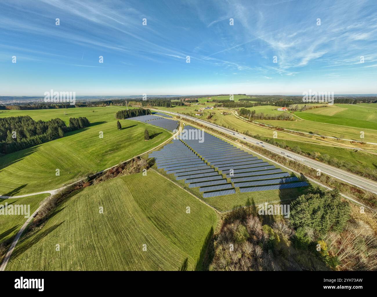 aerial view of a huge photovoltaik power plant next to a highway in ...