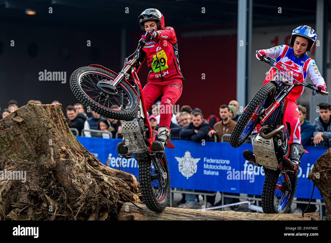 Riders compete on wood obstacles with their motocross bikes in a trial ...