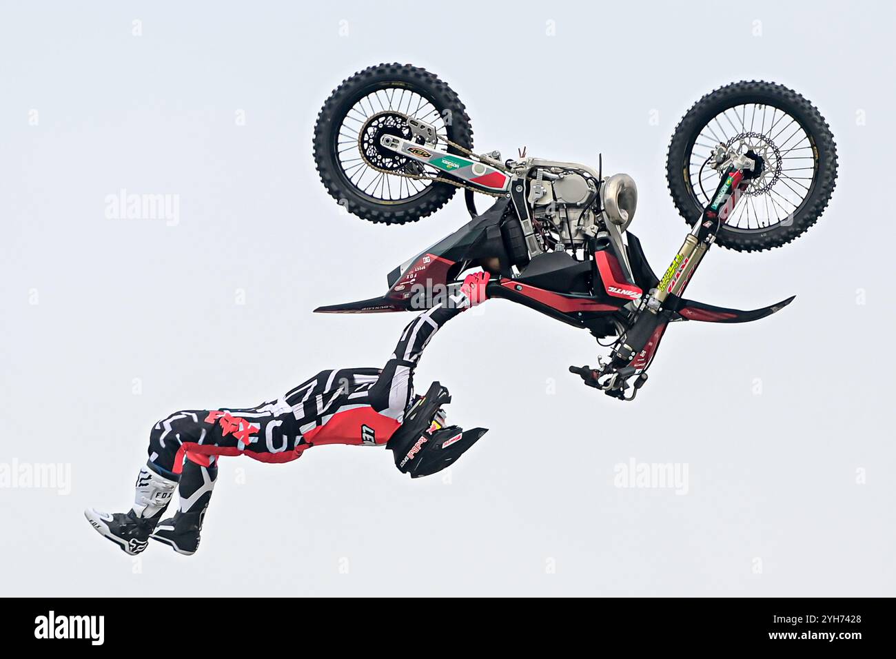 Freestyle motocross FMX rider performs a jump with his bike high in the ...