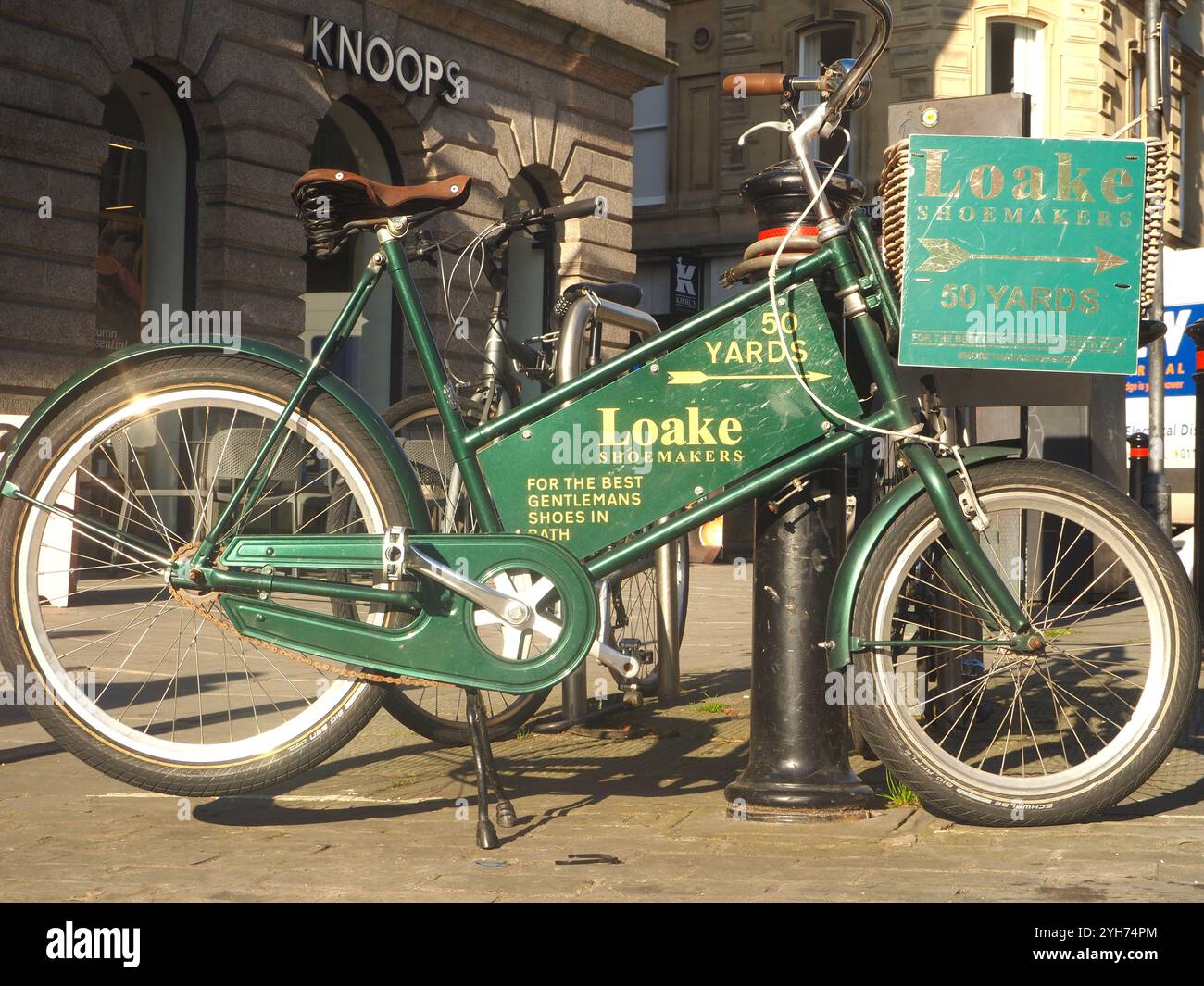 Green repurposed bicycle advertising traditional cobbler Loake ...
