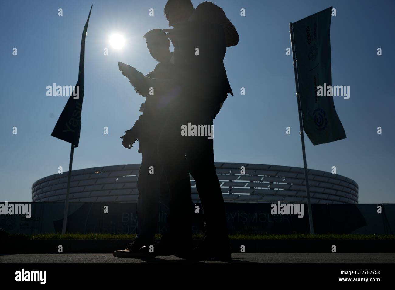 People walk outside the Baku Olympic Stadium, the venue for the COP29 U ...