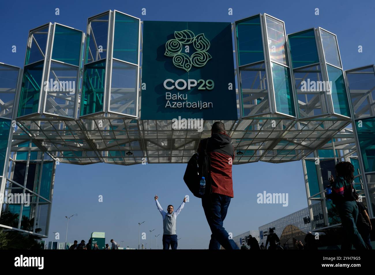 A person poses for a photo outside the COP29 U.N. Climate Summit ...