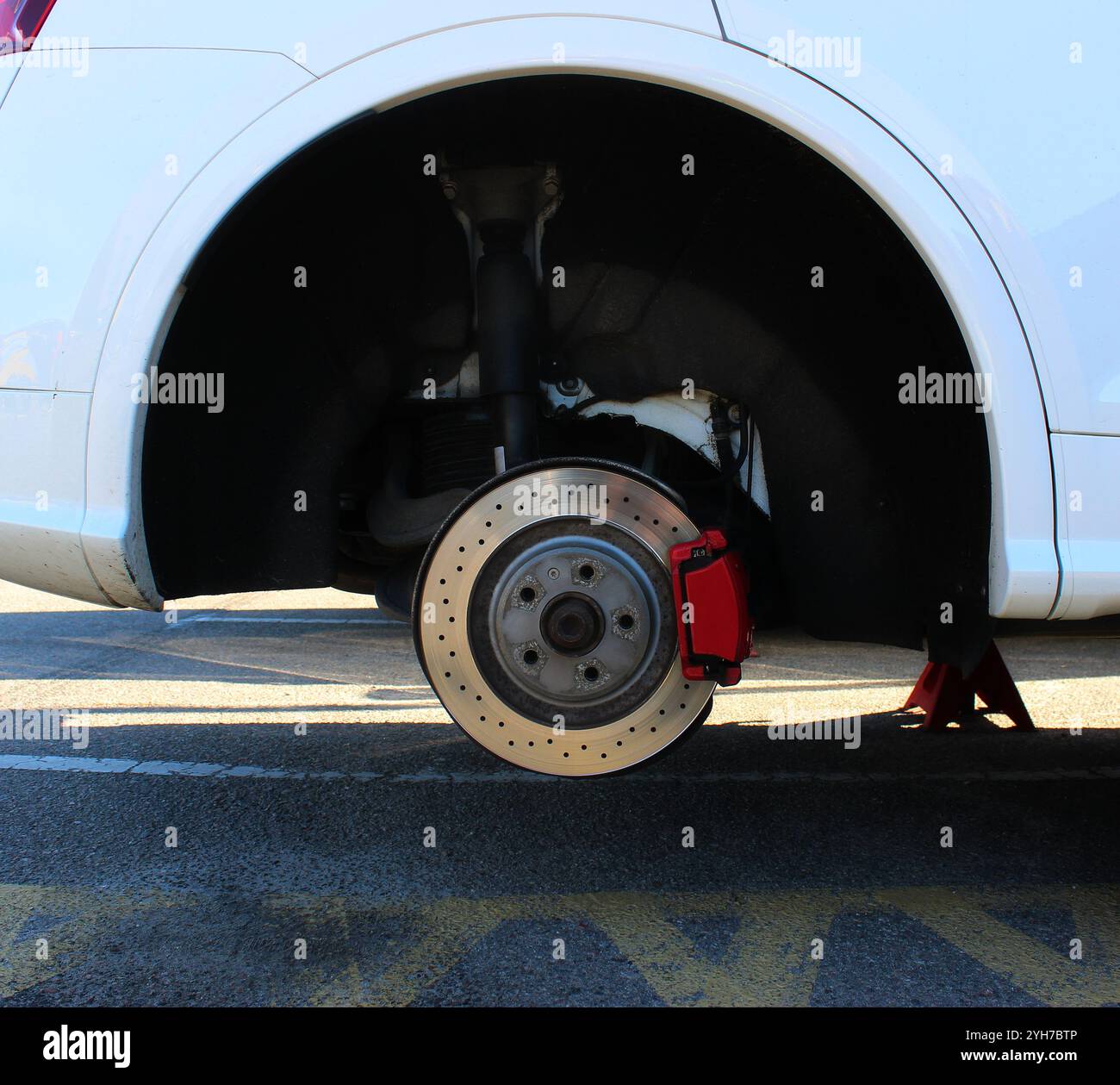 The wheel arch with the wheel removed provides access to check the ...