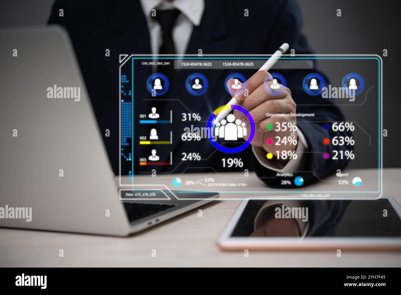 Businessman interacting with a virtual interface showing data analytics and human resource ...