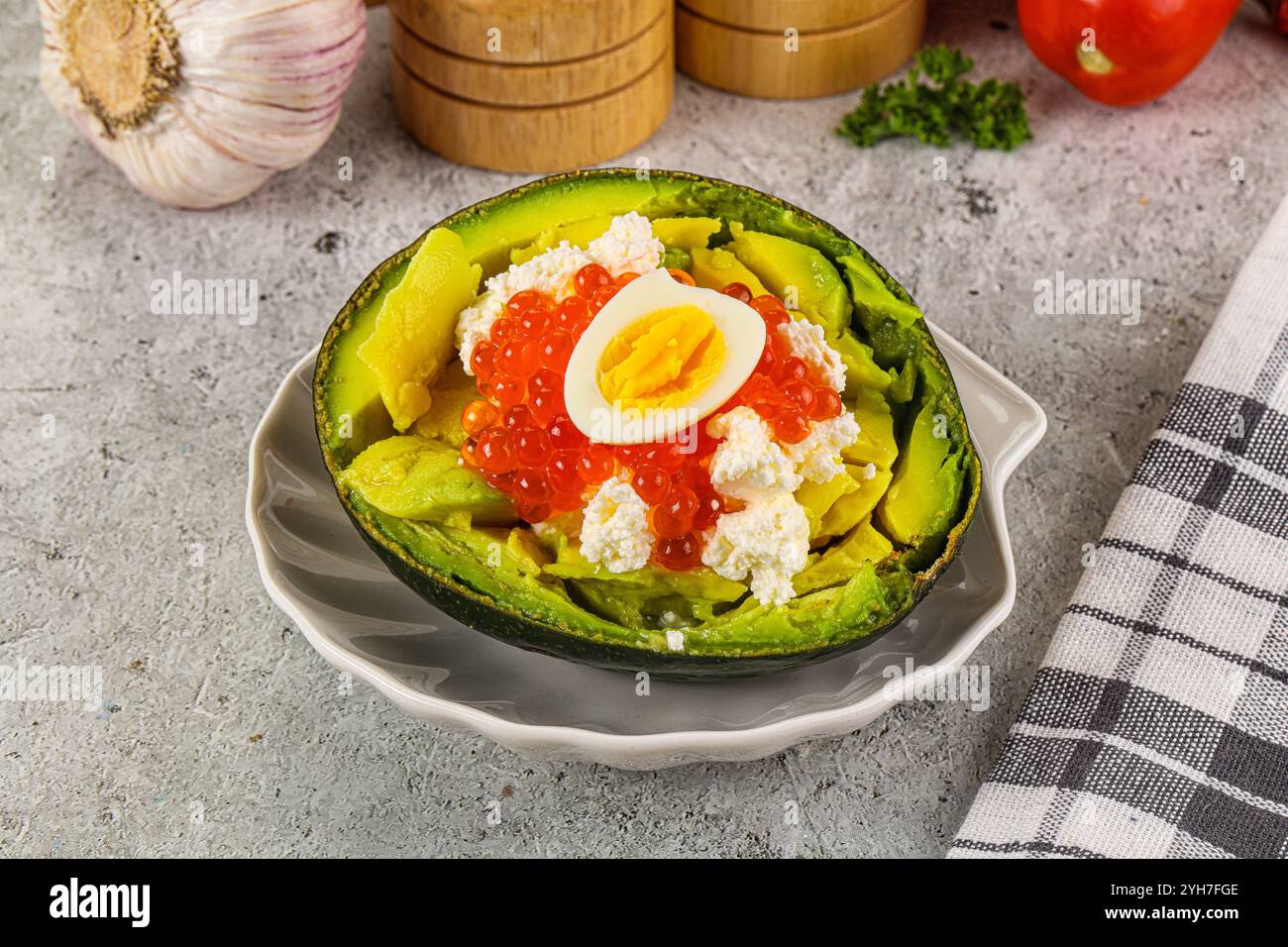 Avocado with red caviar and quil egg and soft cheese Stock Photo - Alamy