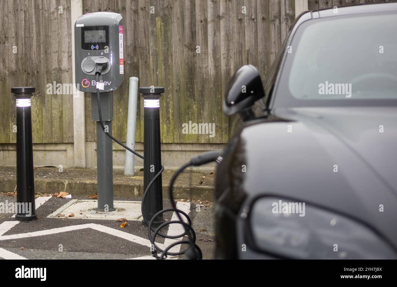 Electric vehicles charging at a public charging point in a council car ...