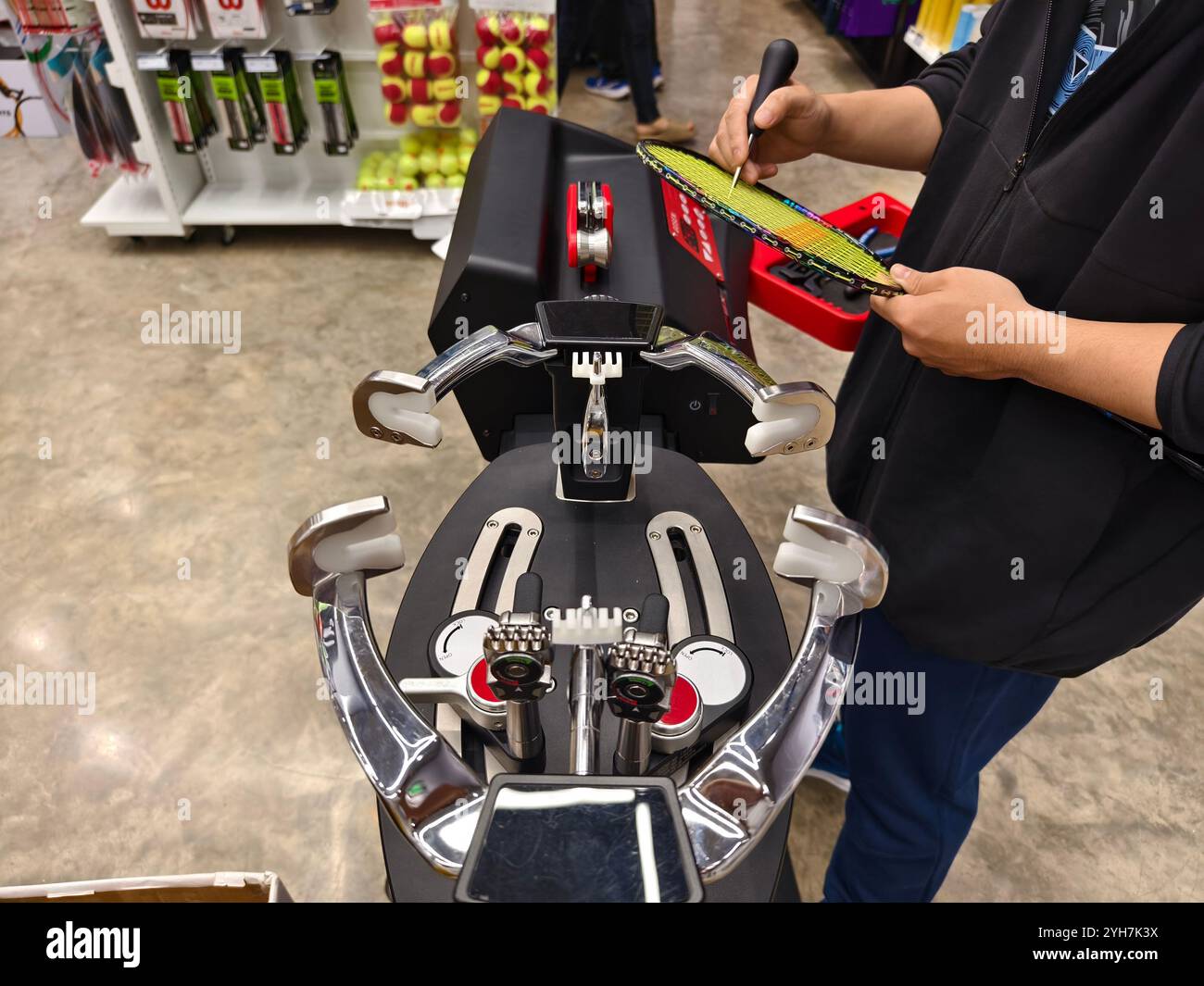 Strings a badminton racket on a racket stringing machine Stock Photo ...