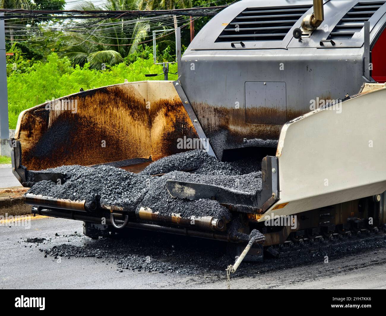 Asphalt paving machine laying down asphalt Stock Photo - Alamy
