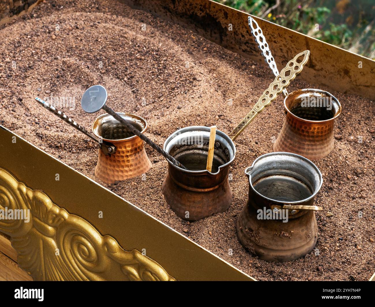 Coffee making on sand. Turkish style coffee preparation with copper ...