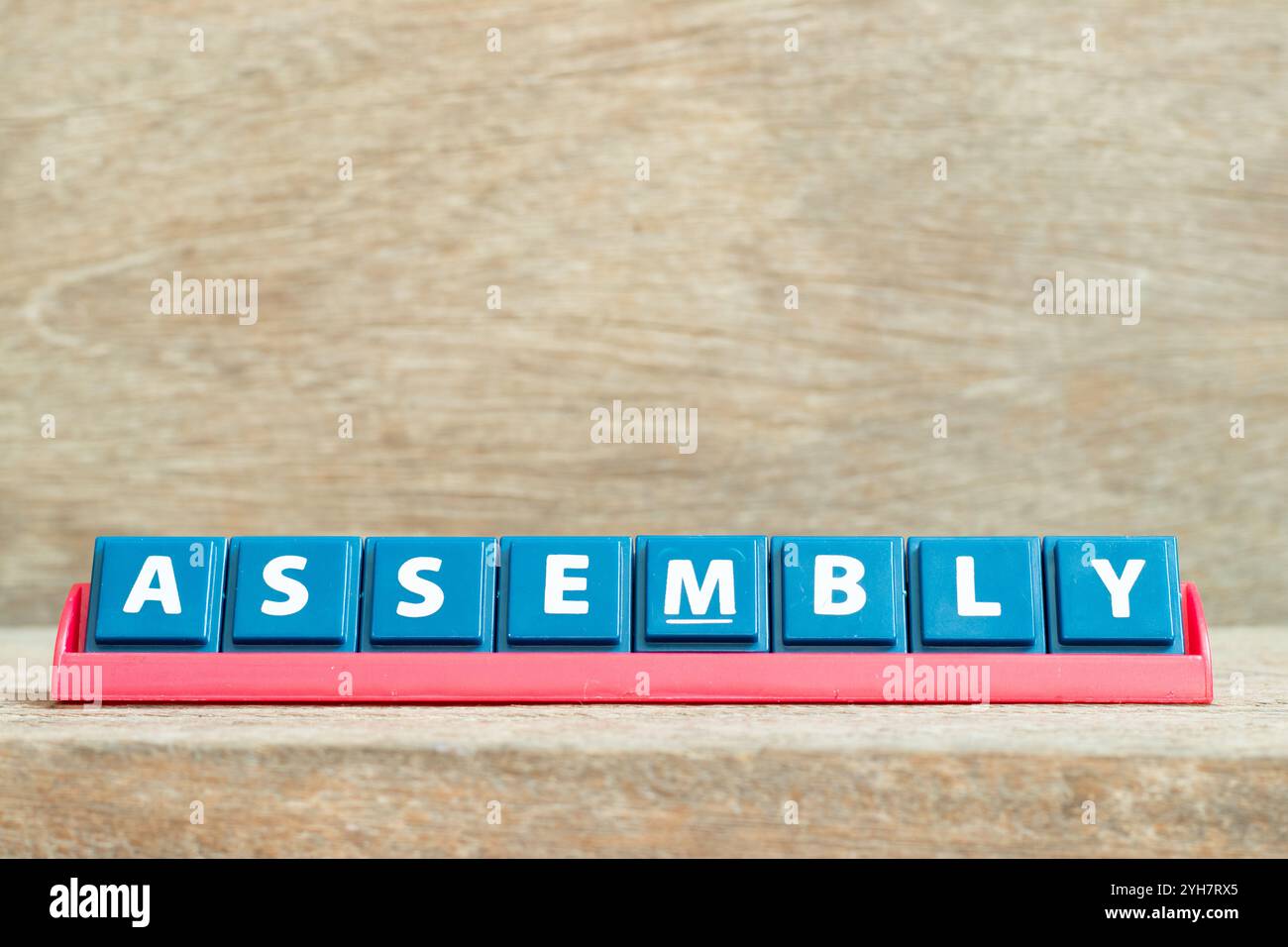 Tile alphabet letter with word assembly in red color rack on wood ...
