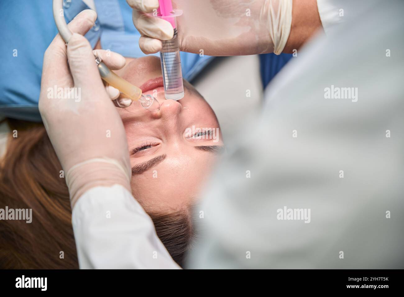 Doctor performs nasal procedure on lying patient Stock Photo - Alamy