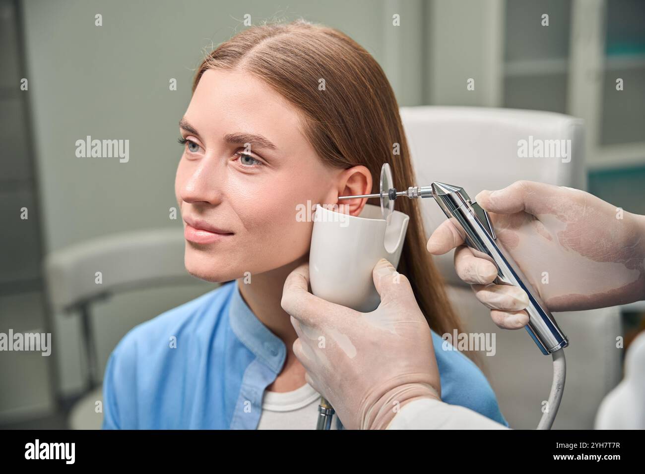 Patient undergoes ear examination with medical tool Stock Photo - Alamy