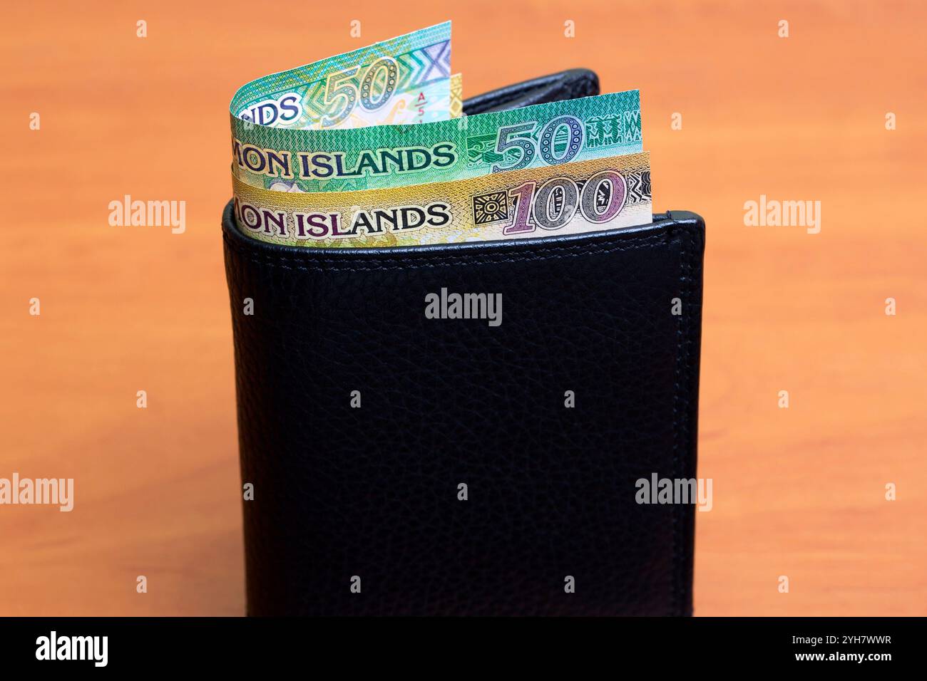 Solomon islands money - dollar - in the black wallet Stock Photo - Alamy